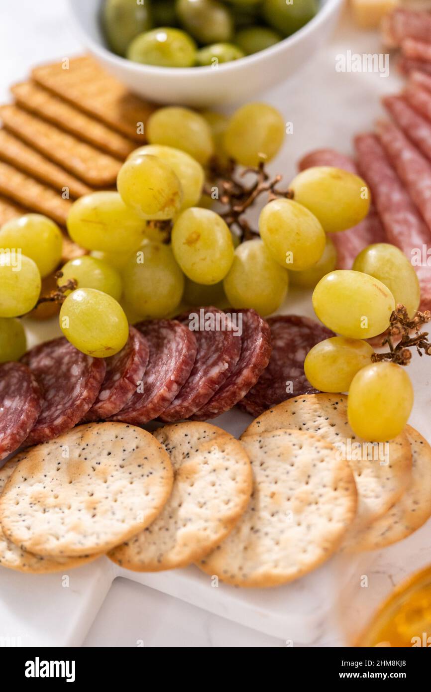 Cheese, meat, and crackers appetizer board on a marble surface Stock ...