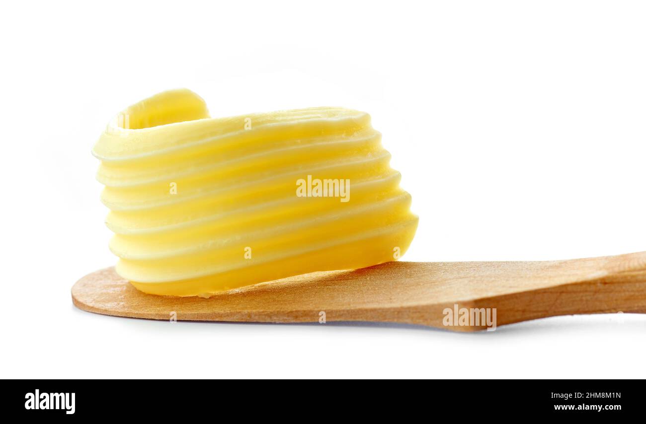butter curl close up on wooden knife isolated on white background Stock ...