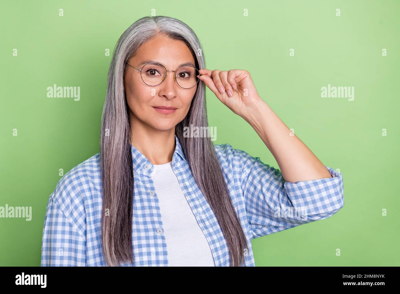 Photo of strict elder grey hairdo lady wear eyewear blue shirt isolated ...