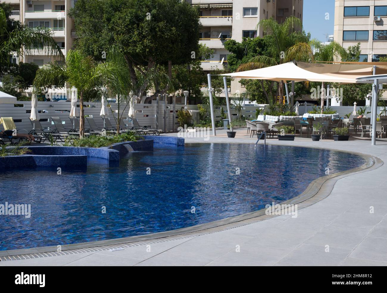 Empty swimming pool. Swimming pool in hotel garden with concrete floor ...