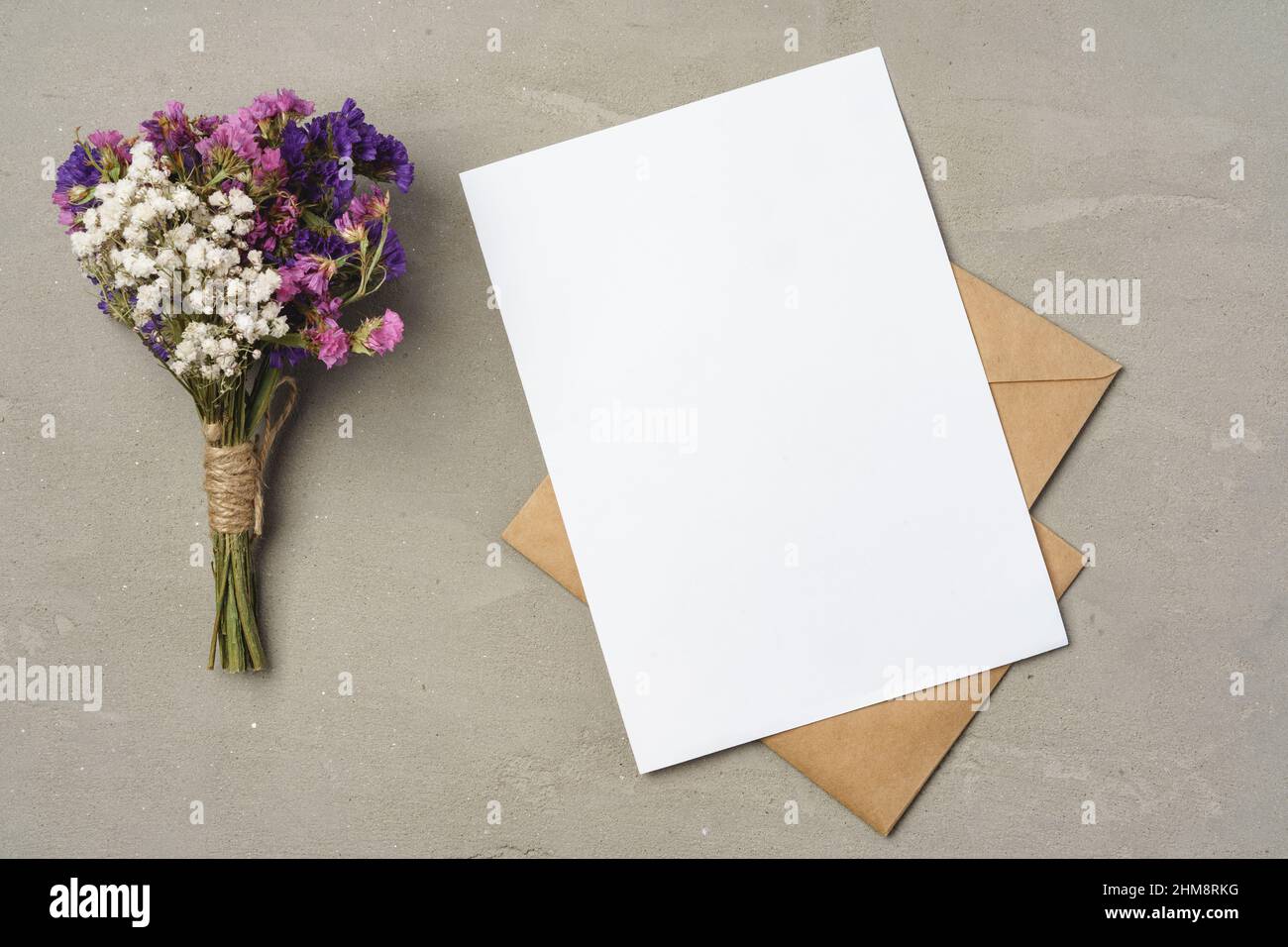 Flowers, blank paper and envelope on a table top Stock Photo - Alamy
