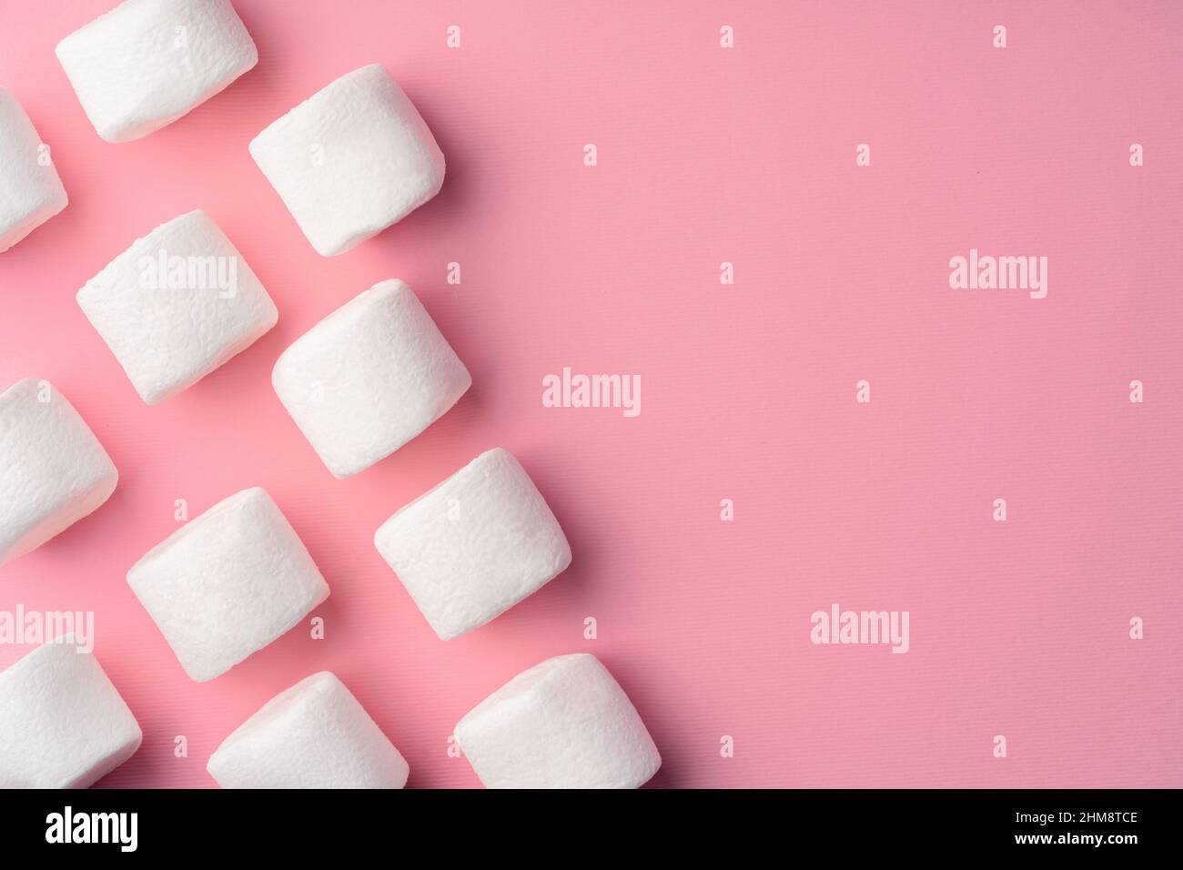 Fluffy marshmallows on pink studio background, top view Stock Photo - Alamy