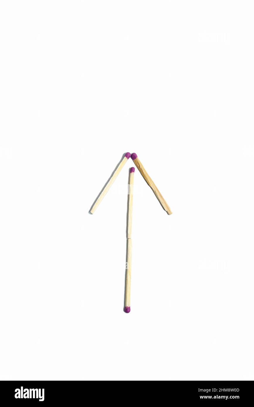 The figure of an arrow laid out from matches directed upwards on a ...