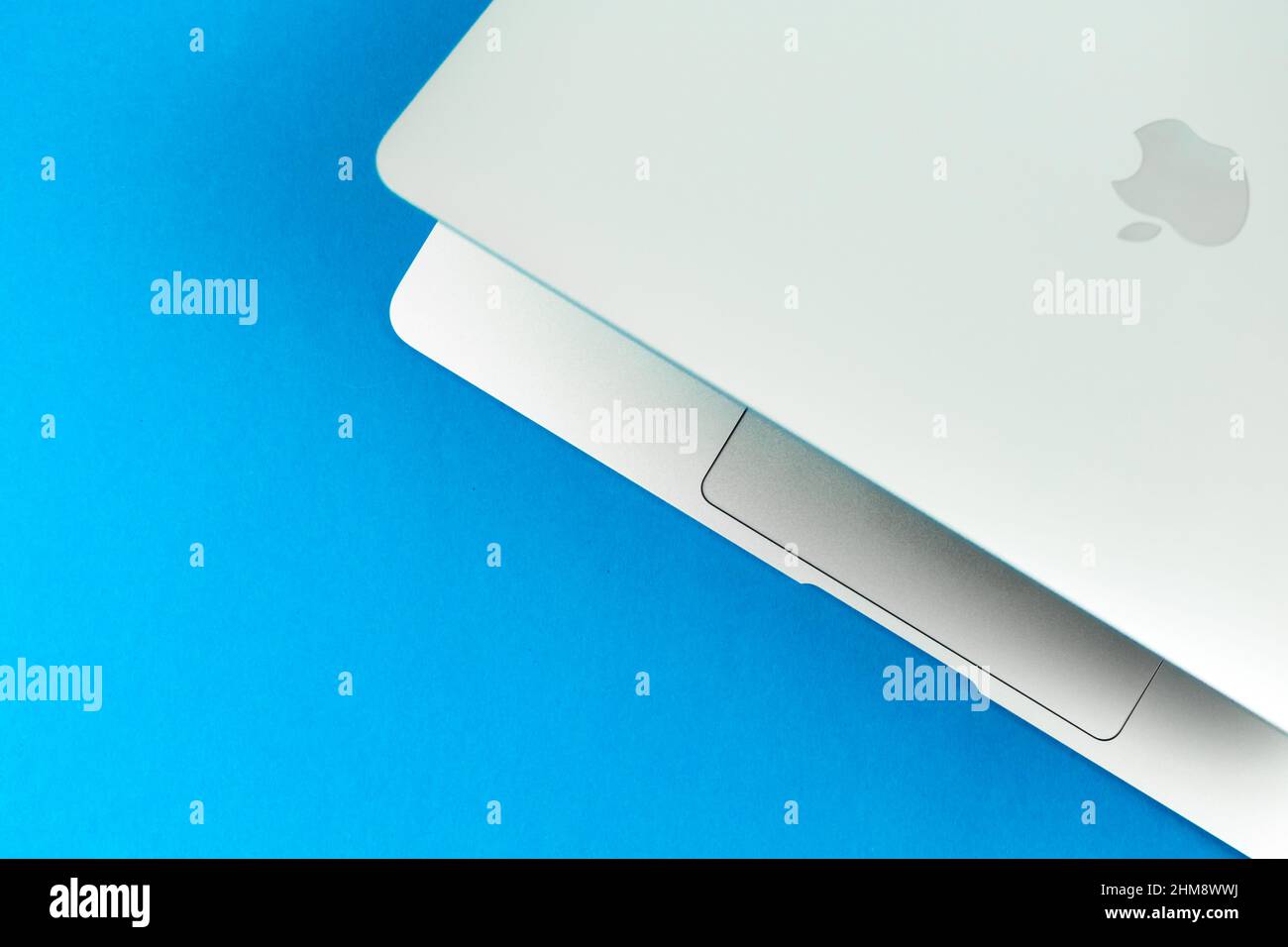 Apple Macbook Air with M1 on bright blue table background. Business and ...