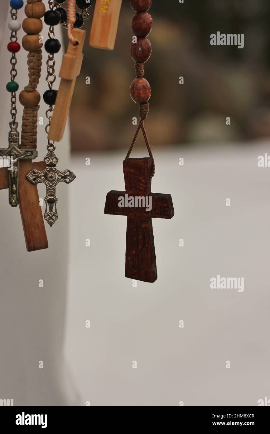 Simple wooden Christian crucifix hanging on a Catholic rosary Stock ...