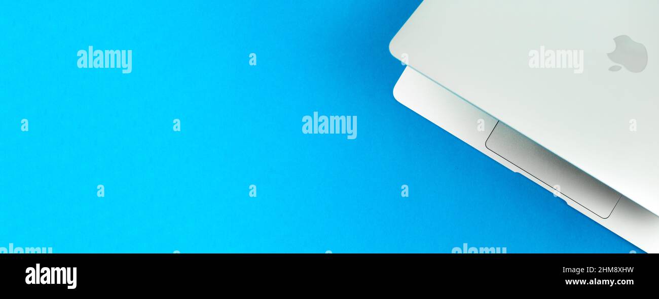 Apple Macbook Air with M1 on bright blue table background. Business and ...