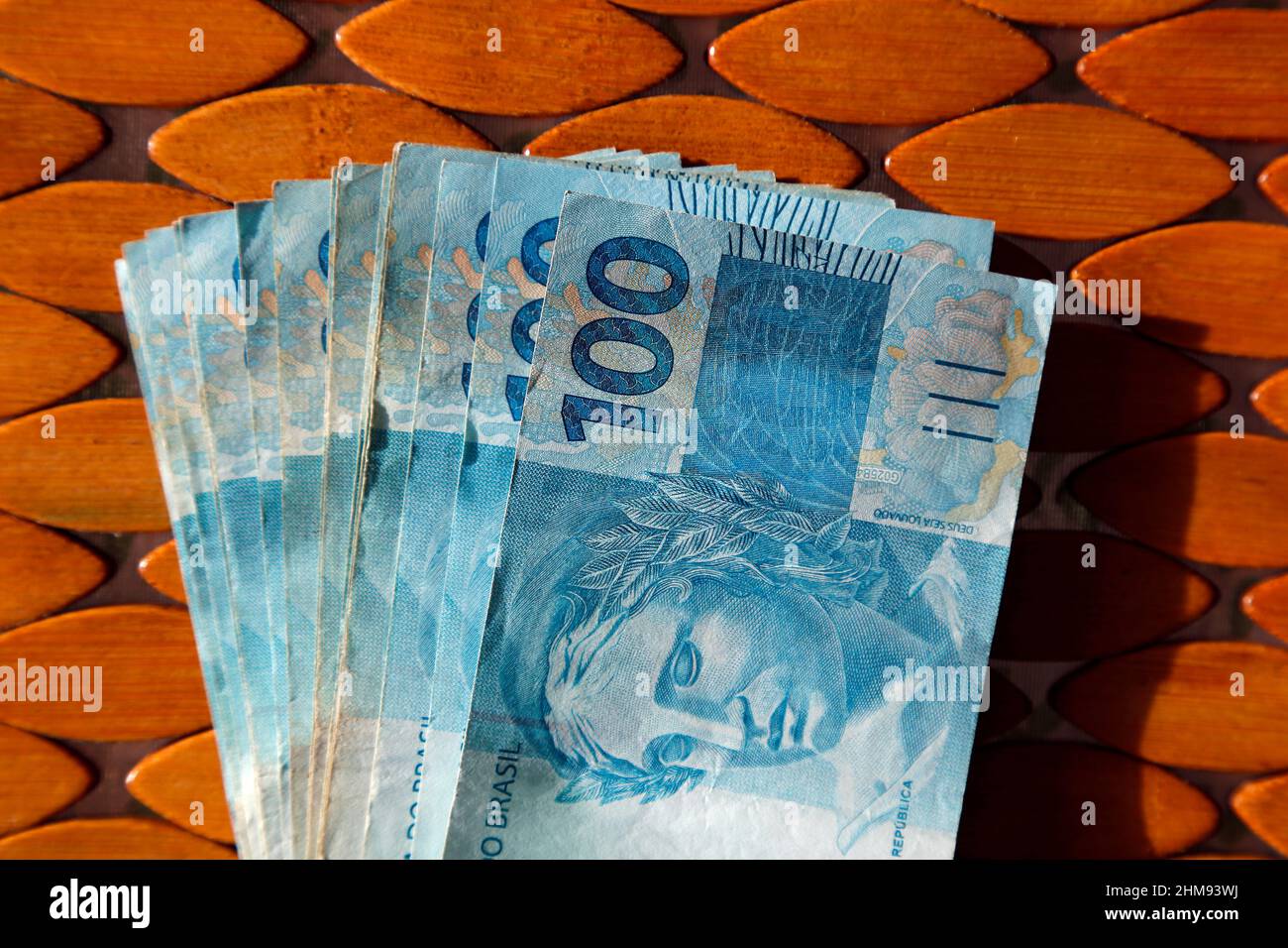 money from brazil stacked on a matte surface and directed light ...