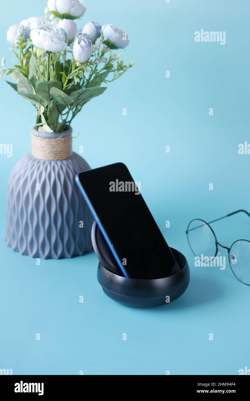 charging Smartphone using Wireless Charging Pad, top view Stock Photo ...