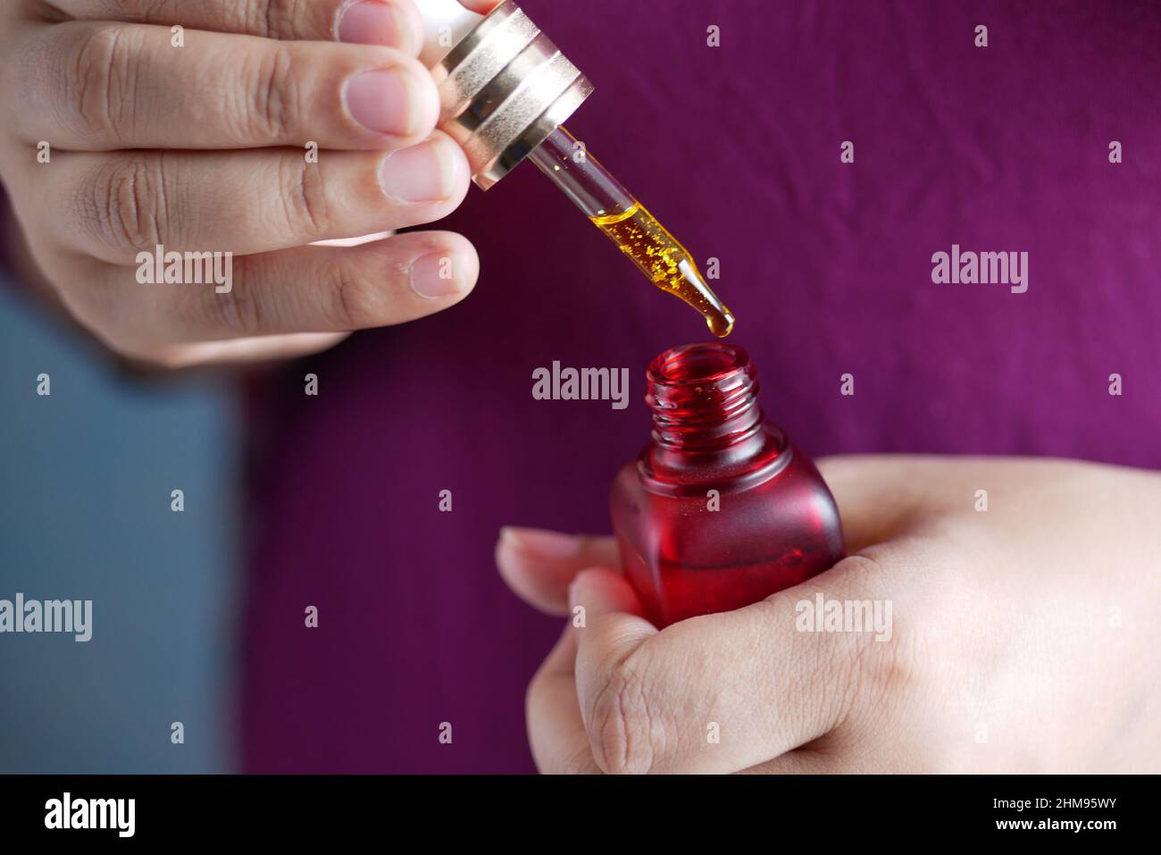 women hand Drop falls from a pipette into a cosmetic bottle Stock Photo ...
