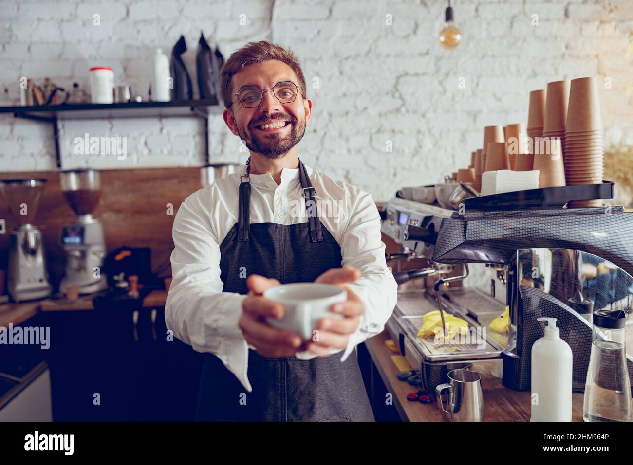Young male barista cup hi-res stock photography and images - Alamy