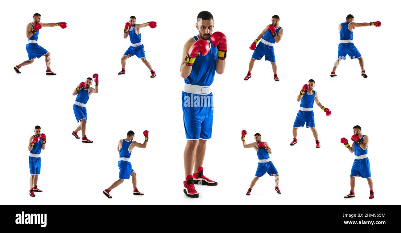Strong fists. One professional boxer in blue uniform training isolated ...