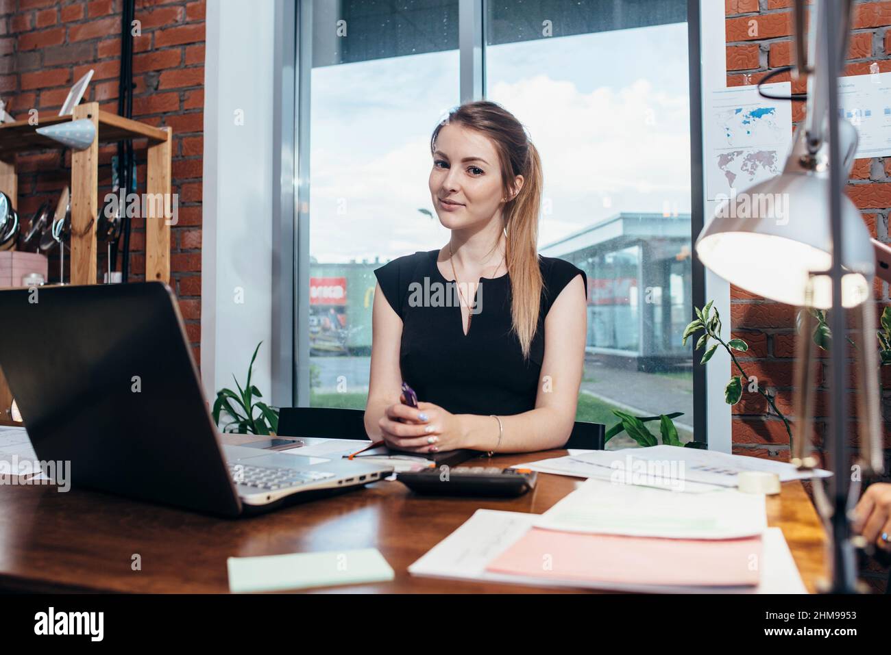 Business woman working at the office looking at camera Stock Photo - Alamy