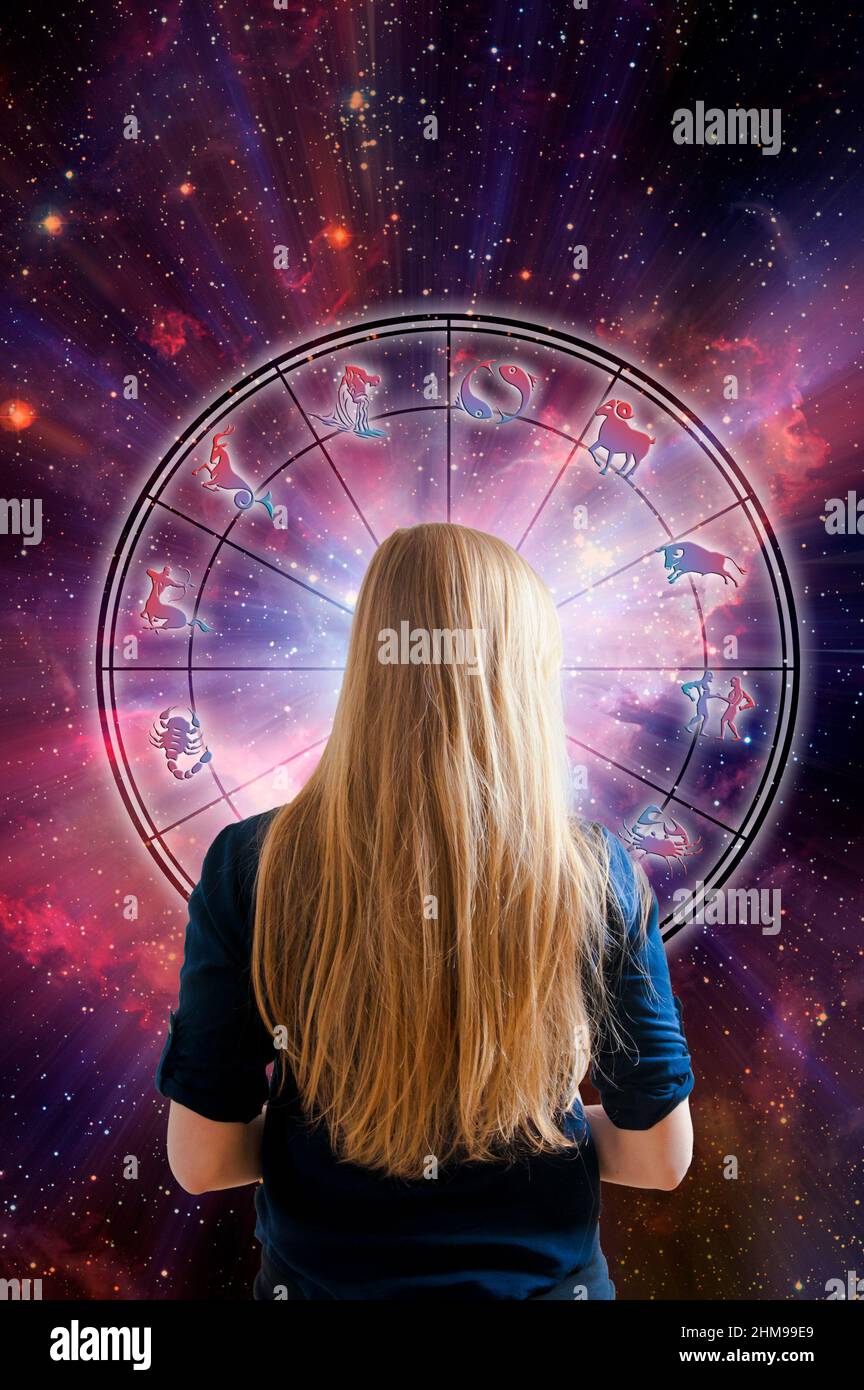 blonde woman in front of a wheel with zodiac signs Stock Photo - Alamy
