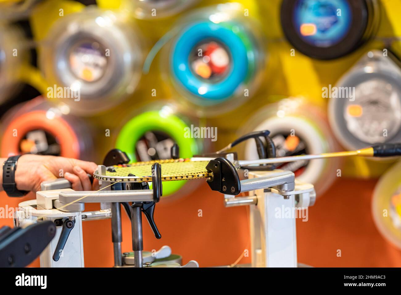 manual stringing of a badminton racket in service Stock Photo - Alamy