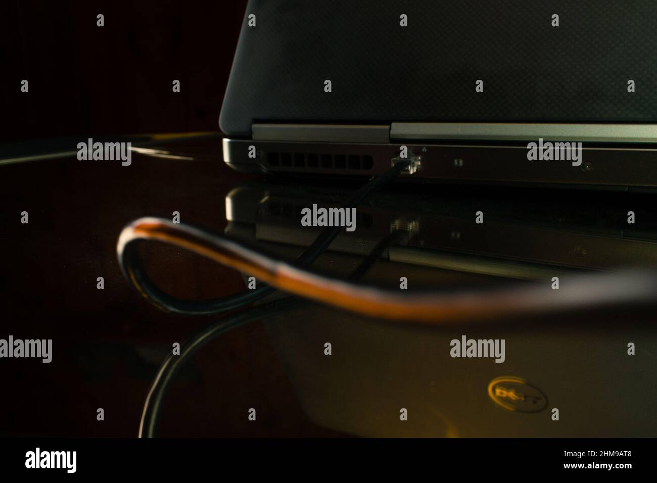 Ethernet cable plugged into a laptop in a dark room Stock Photo - Alamy