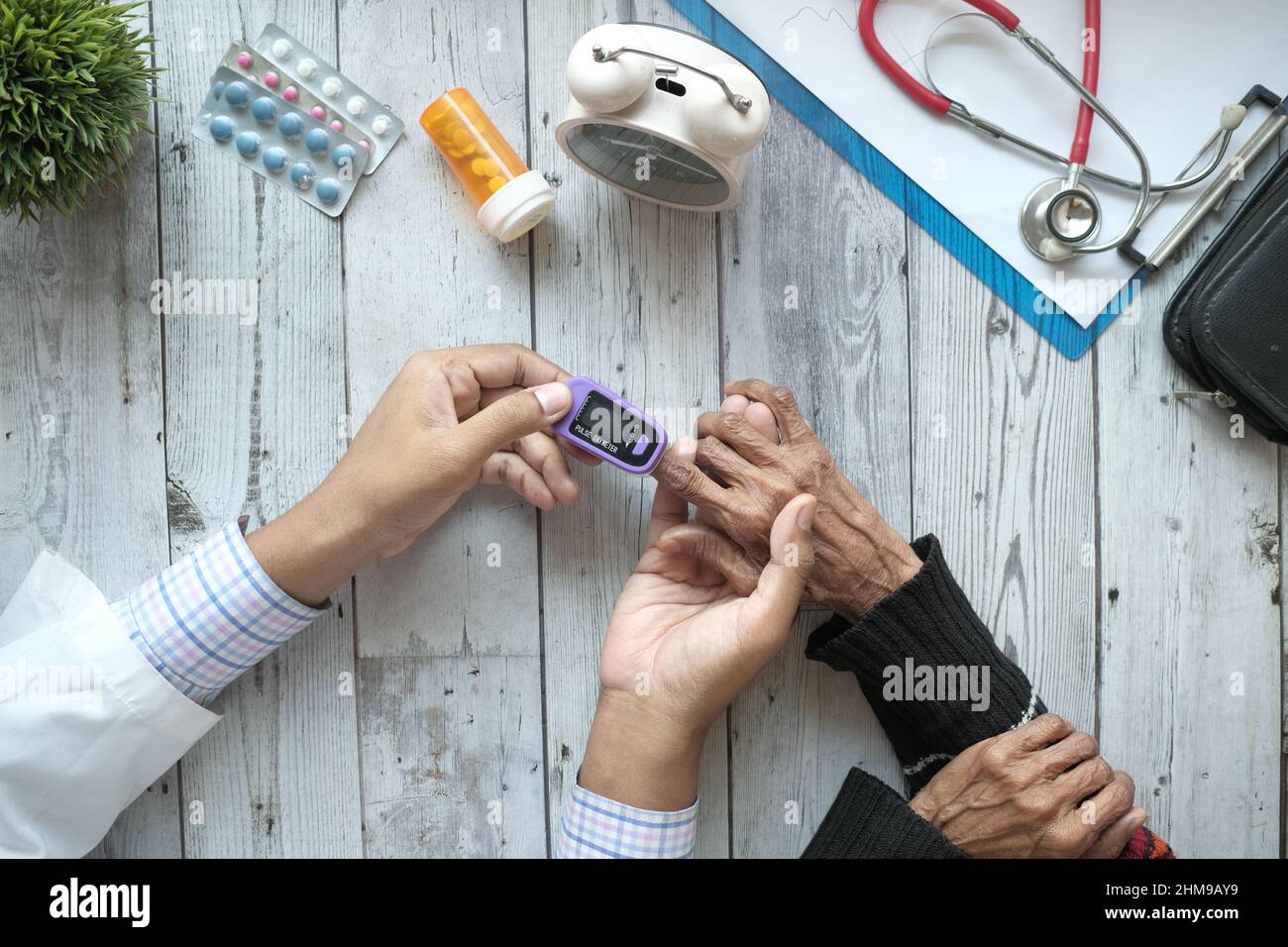 doctor helping senior patient measuring pulse rate Stock Photo - Alamy
