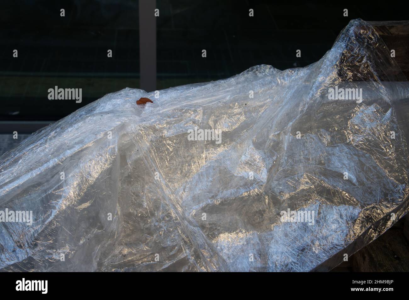Old used plastic wrap lying on the sidewalk Stock Photo - Alamy
