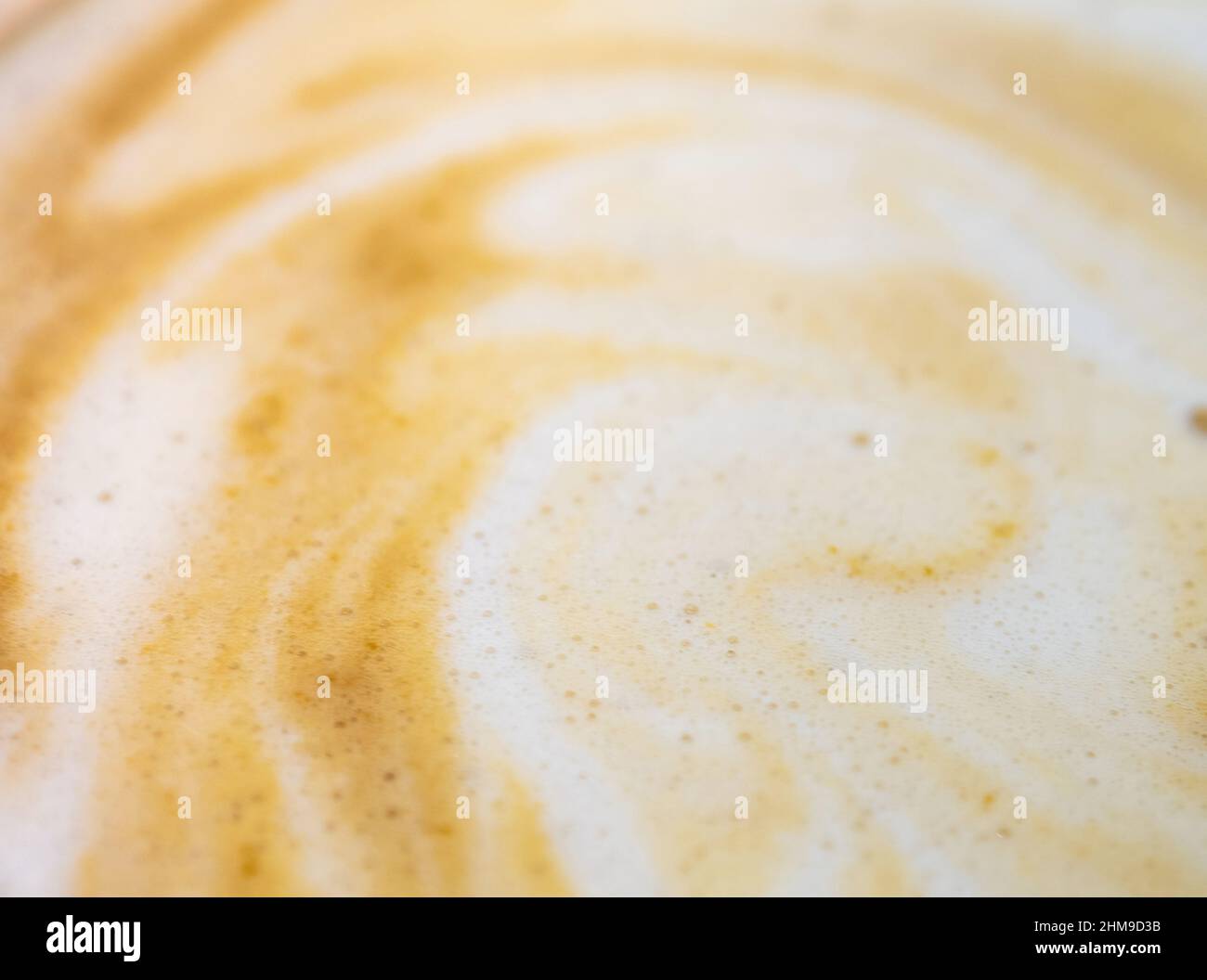 Full-frame close-up texture surface of soft and delicate milk froth in ...