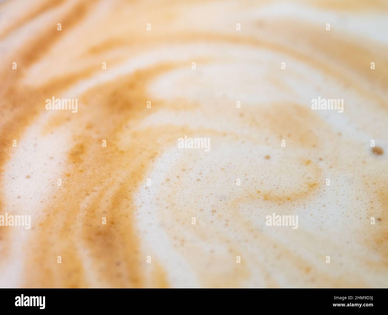 Full-frame close-up texture surface of soft and delicate milk froth in ...