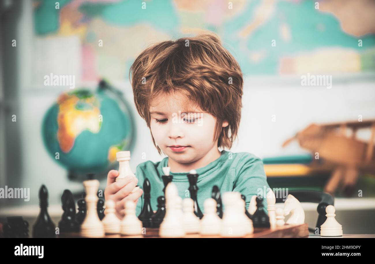 Preschooler or schoolboy, Thinking kid. Kid playing chess in the room ...