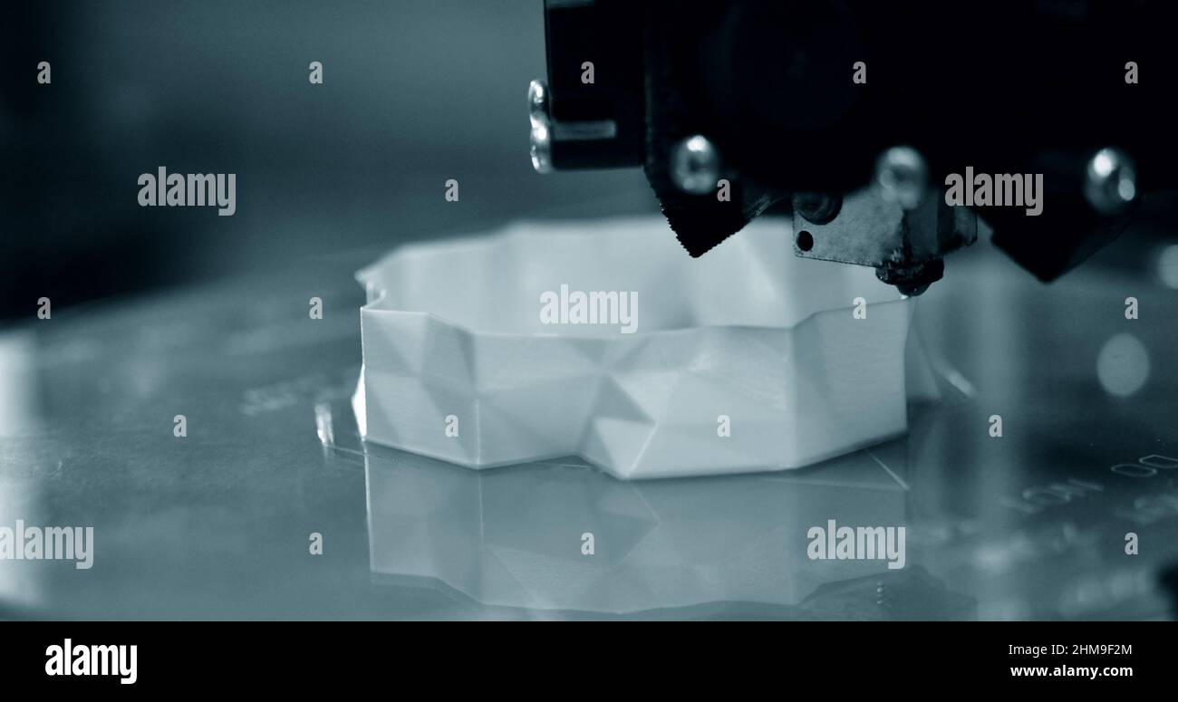 3d printer while printing a blue object close-up Stock Photo - Alamy