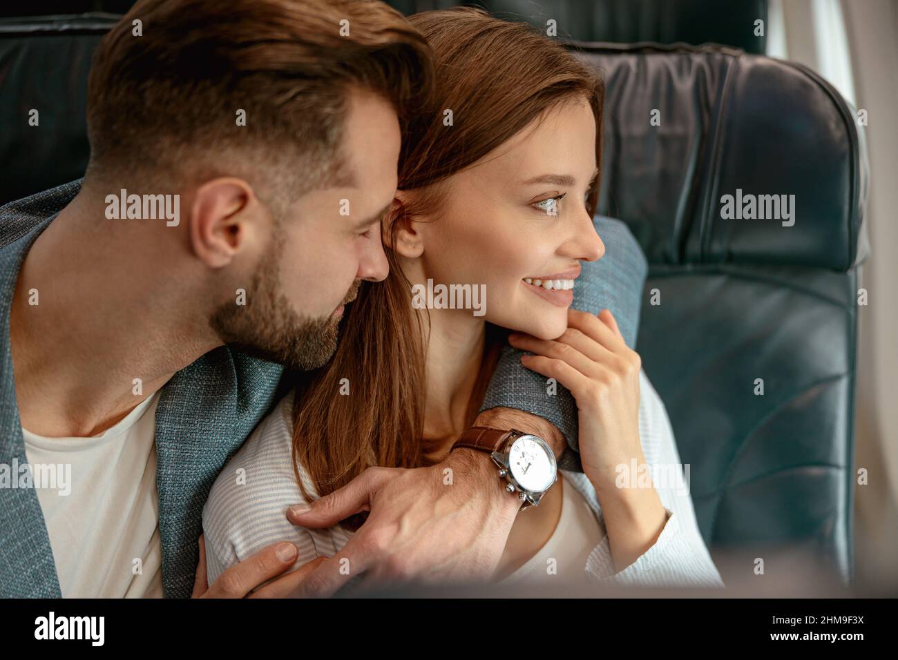 Couple in love hugging in passenger airplane Stock Photo - Alamy