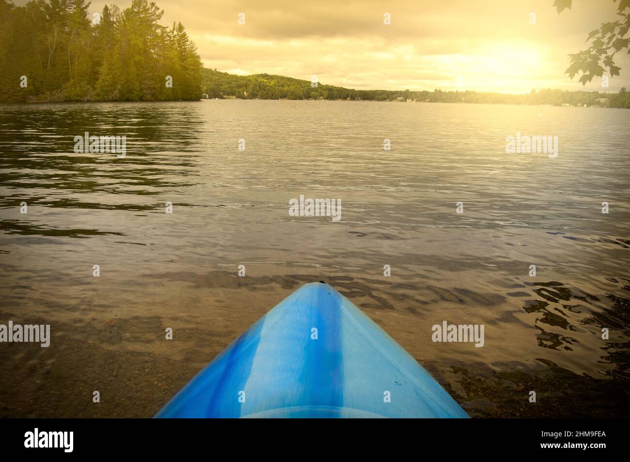 Blue Plastic Kayak with Sunset and Water Reflections Horizontal Stock ...