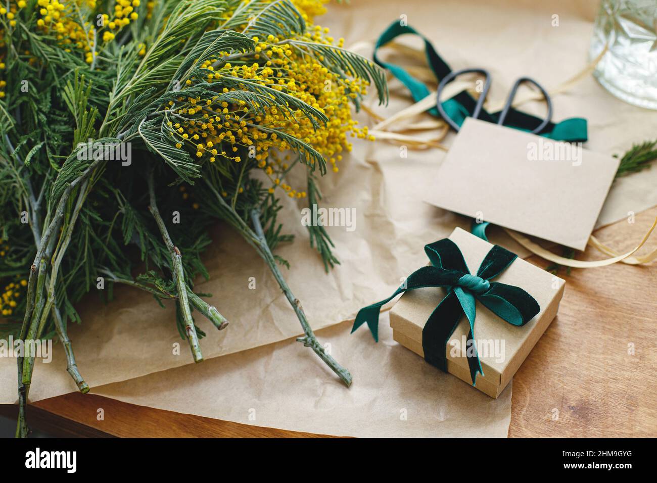 Happy womens day and Happy Mothers day. Stylish mimosa bouquet and gift ...