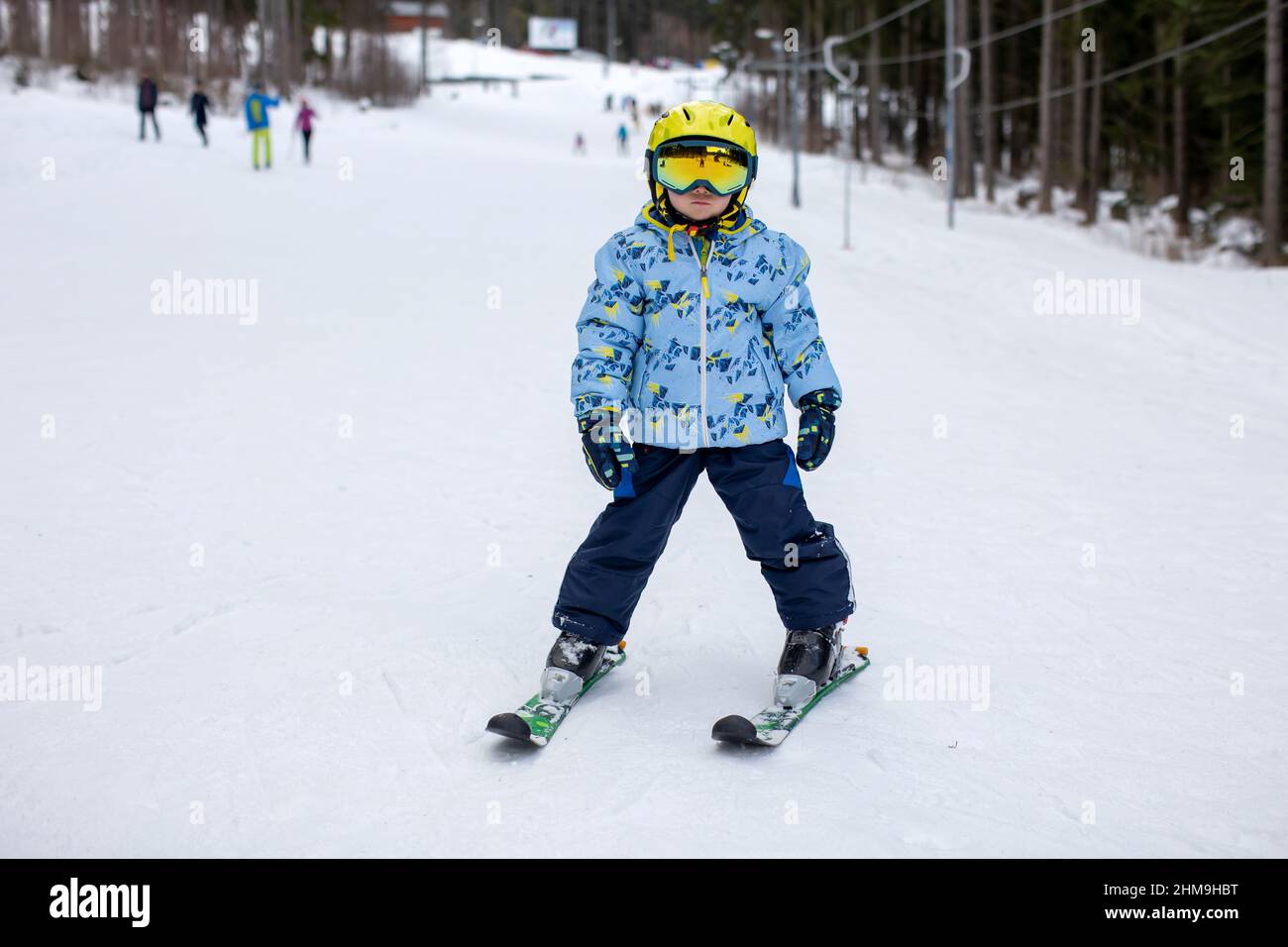 Little toddler boy, preschool child, skiing for the first time on small ...