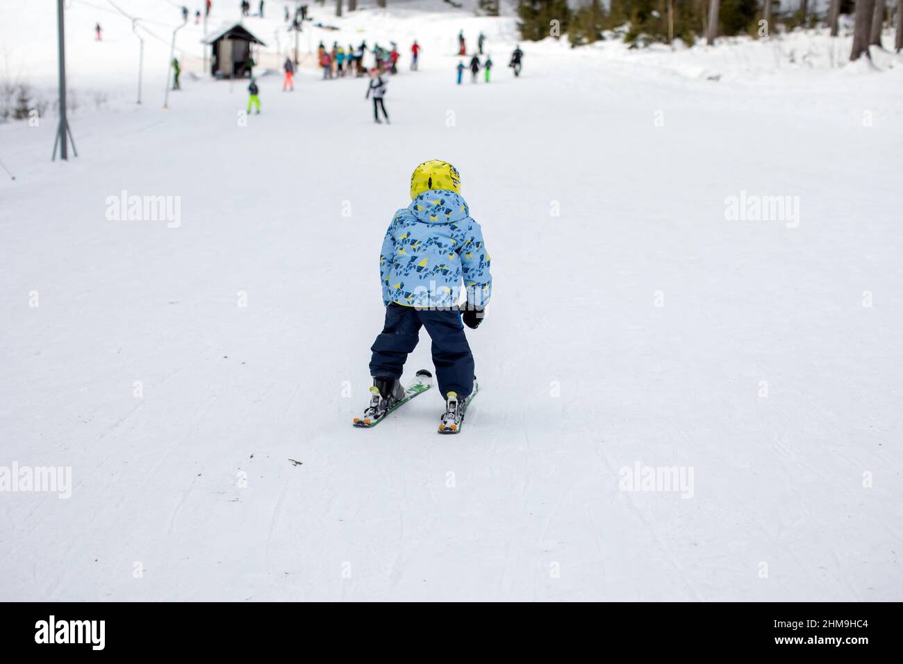 Little toddler boy, preschool child, skiing for the first time on small ...