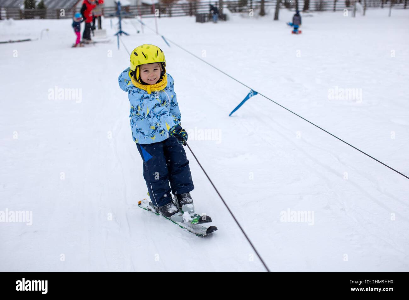 Little toddler boy, preschool child, skiing for the first time on small ...