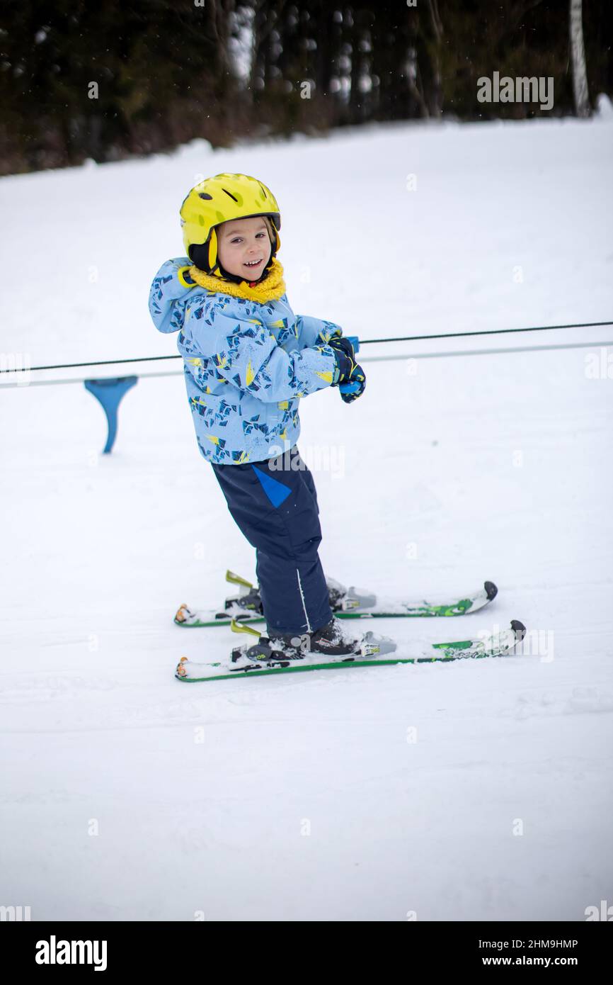 Little toddler boy, preschool child, skiing for the first time on small ...
