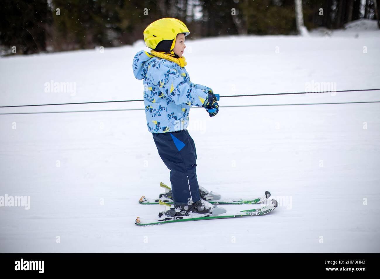 Little toddler boy, preschool child, skiing for the first time on small ...