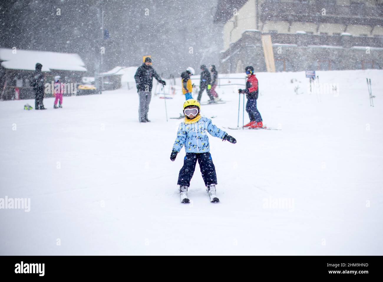 Little toddler boy, preschool child, skiing for the first time on small ...