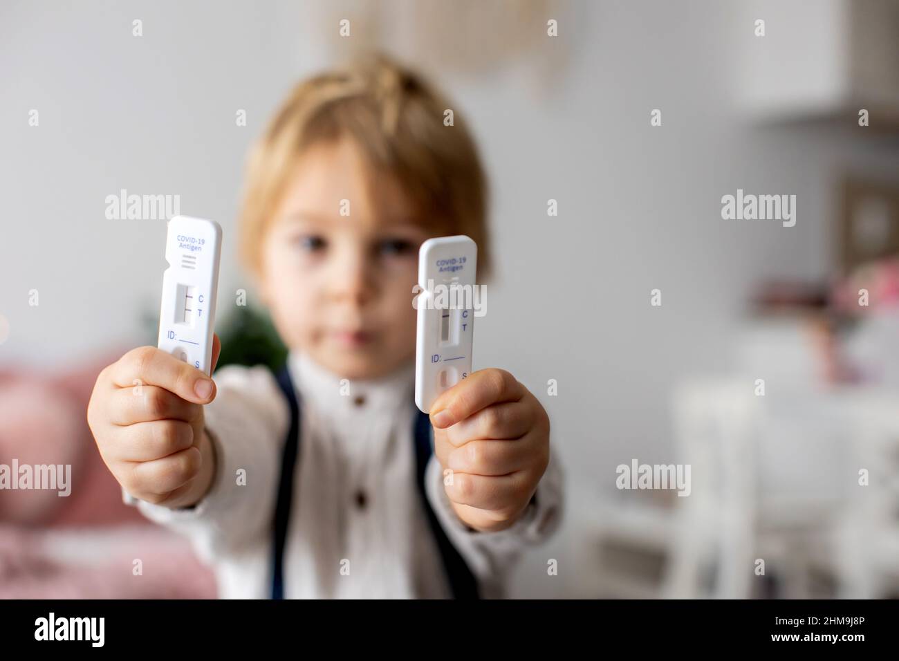 Child, holding two home made covid 19 SWAB antigen test, home allowed ...