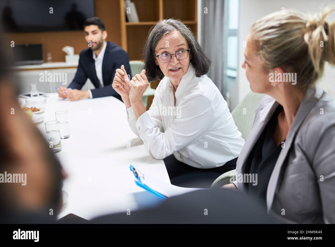 Two business women in a discussion at the business meeting in the ...