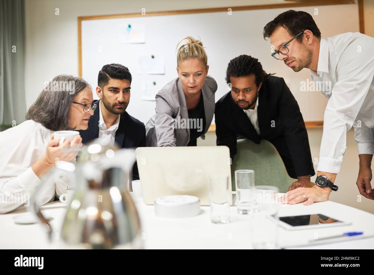 Business people look intently at the monitor from the laptop computer ...