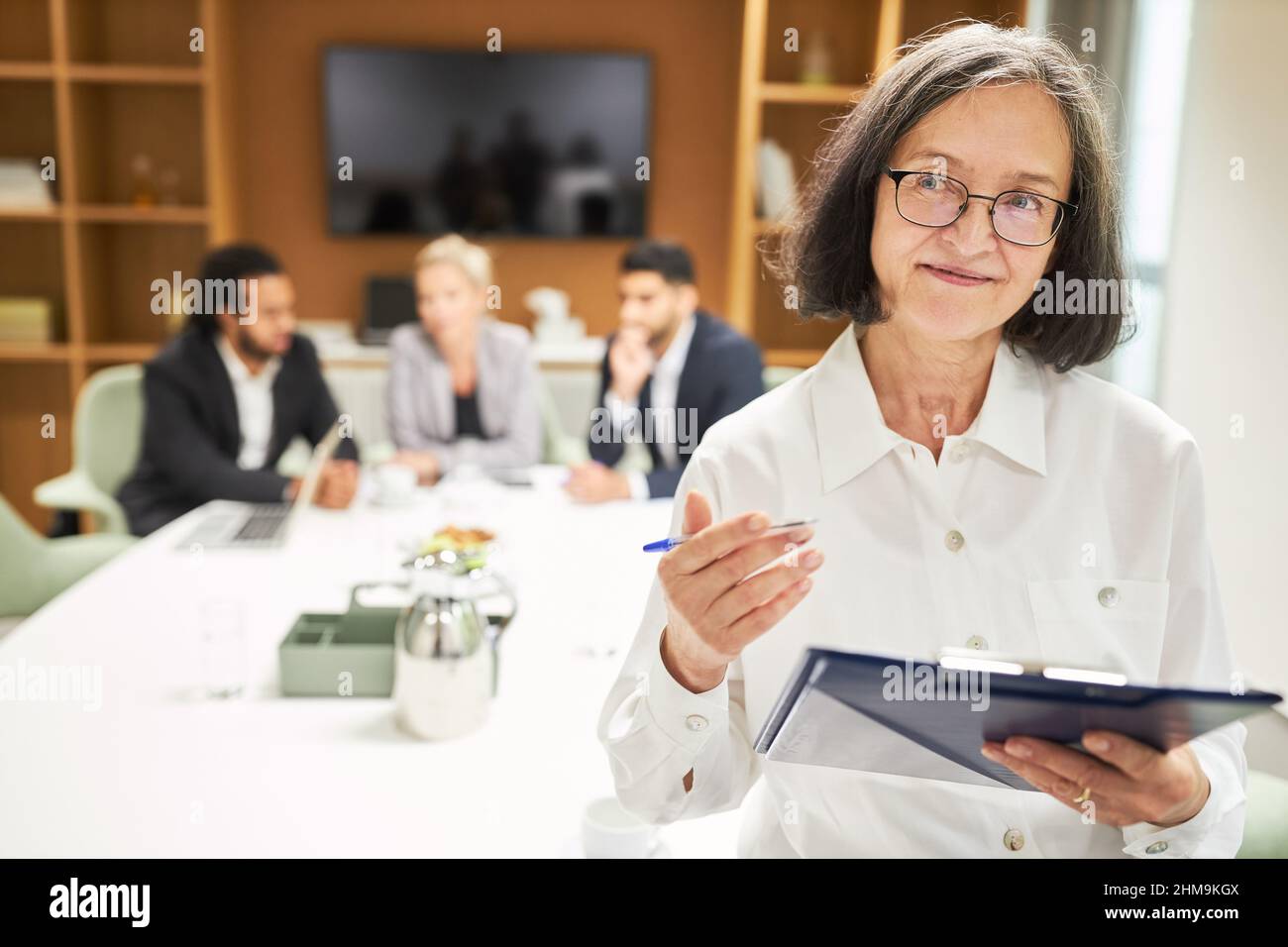 Senior business woman as manager with clipboard and checklist while ...