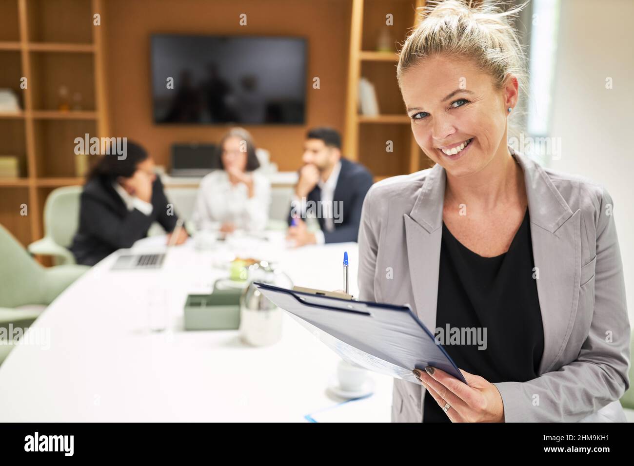 Happy business woman with checklist on clipboard making notes in ...