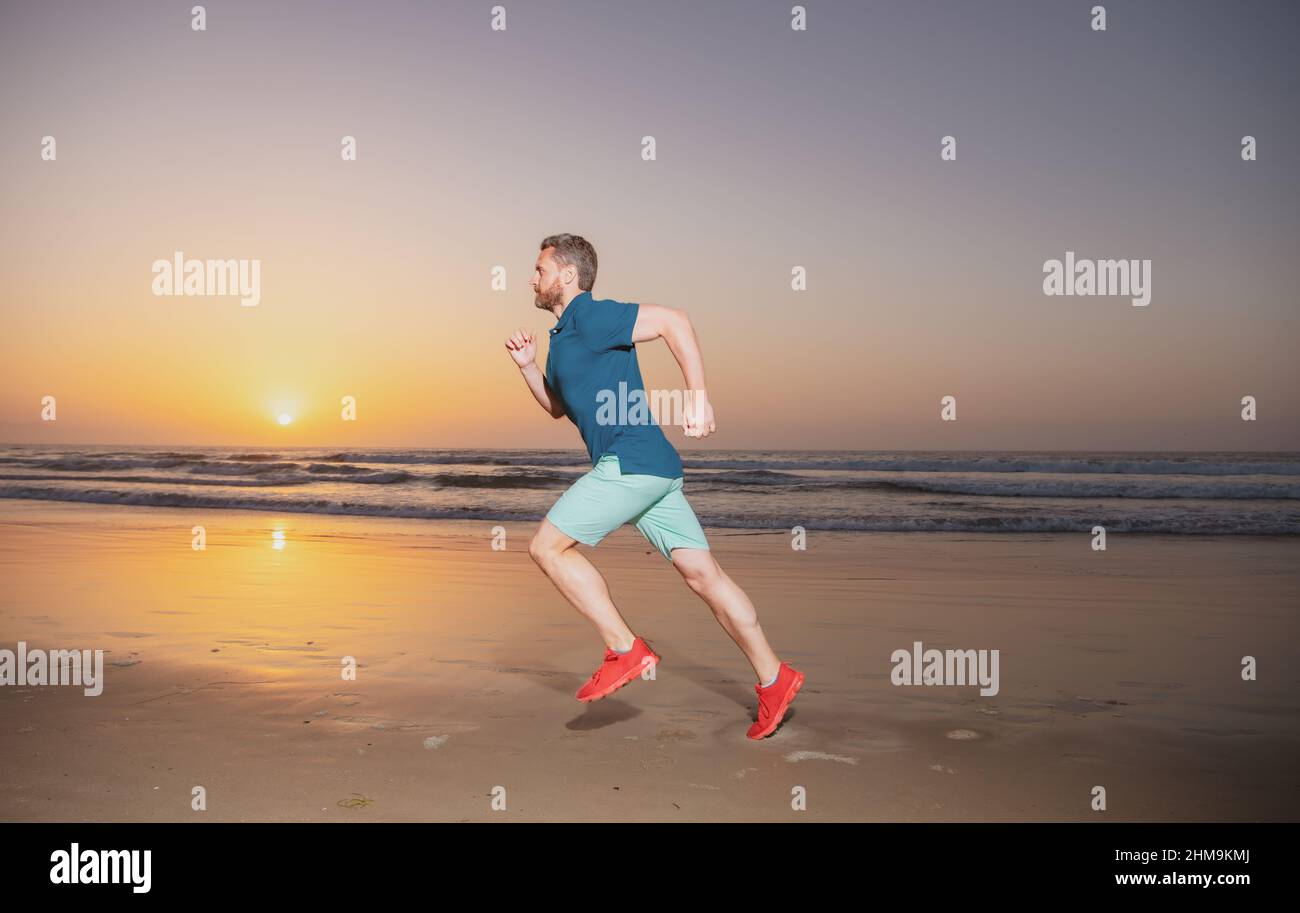 Full length of healthy man running and sprinting outdoors. Male runner ...