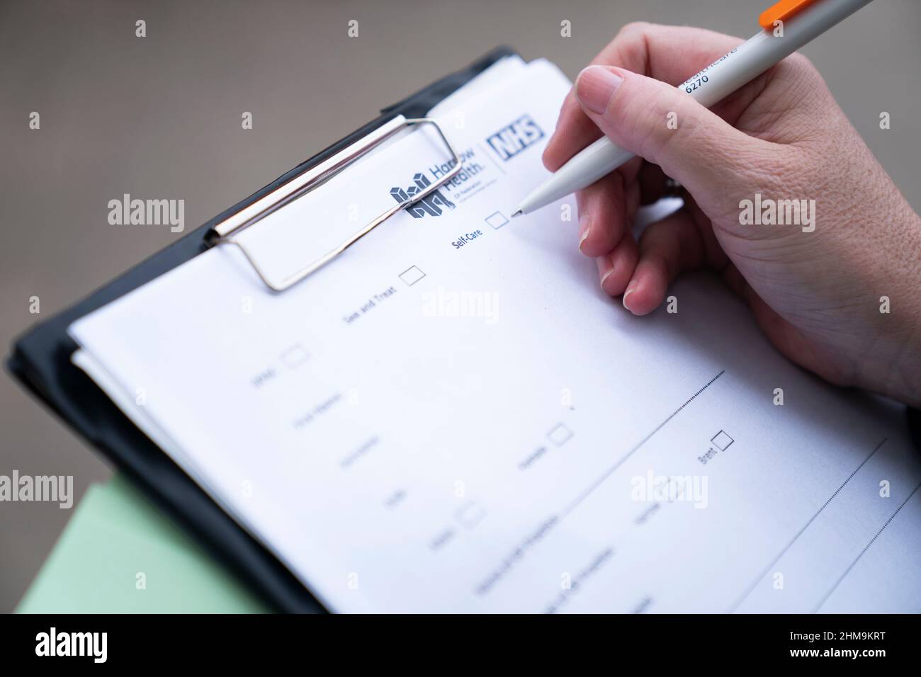 A patient form to be filled in on arrival, advising if they should self ...