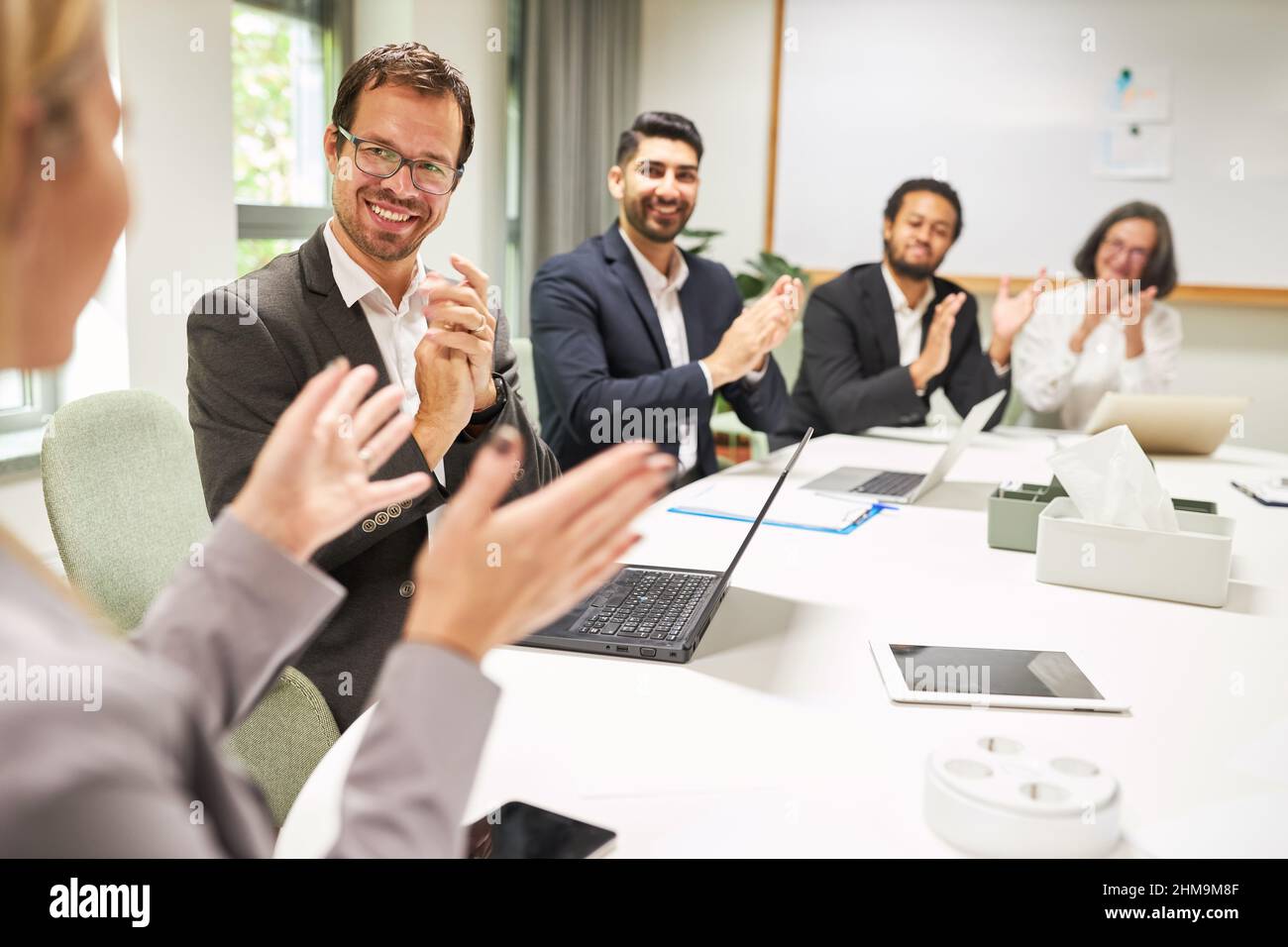 Business people clapping and applauding after a presentation or ...