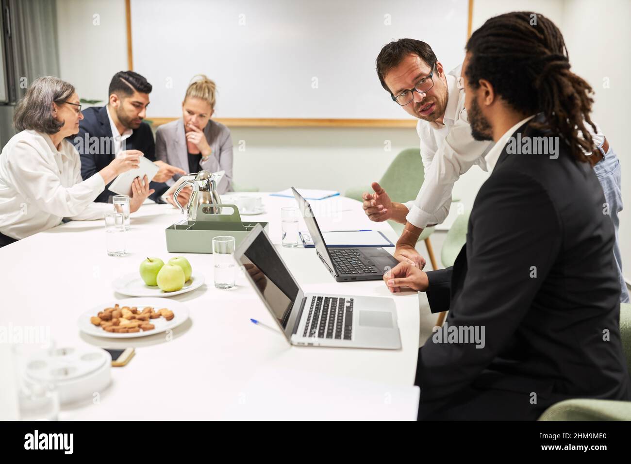 Group of business people in conference room using computers during ...