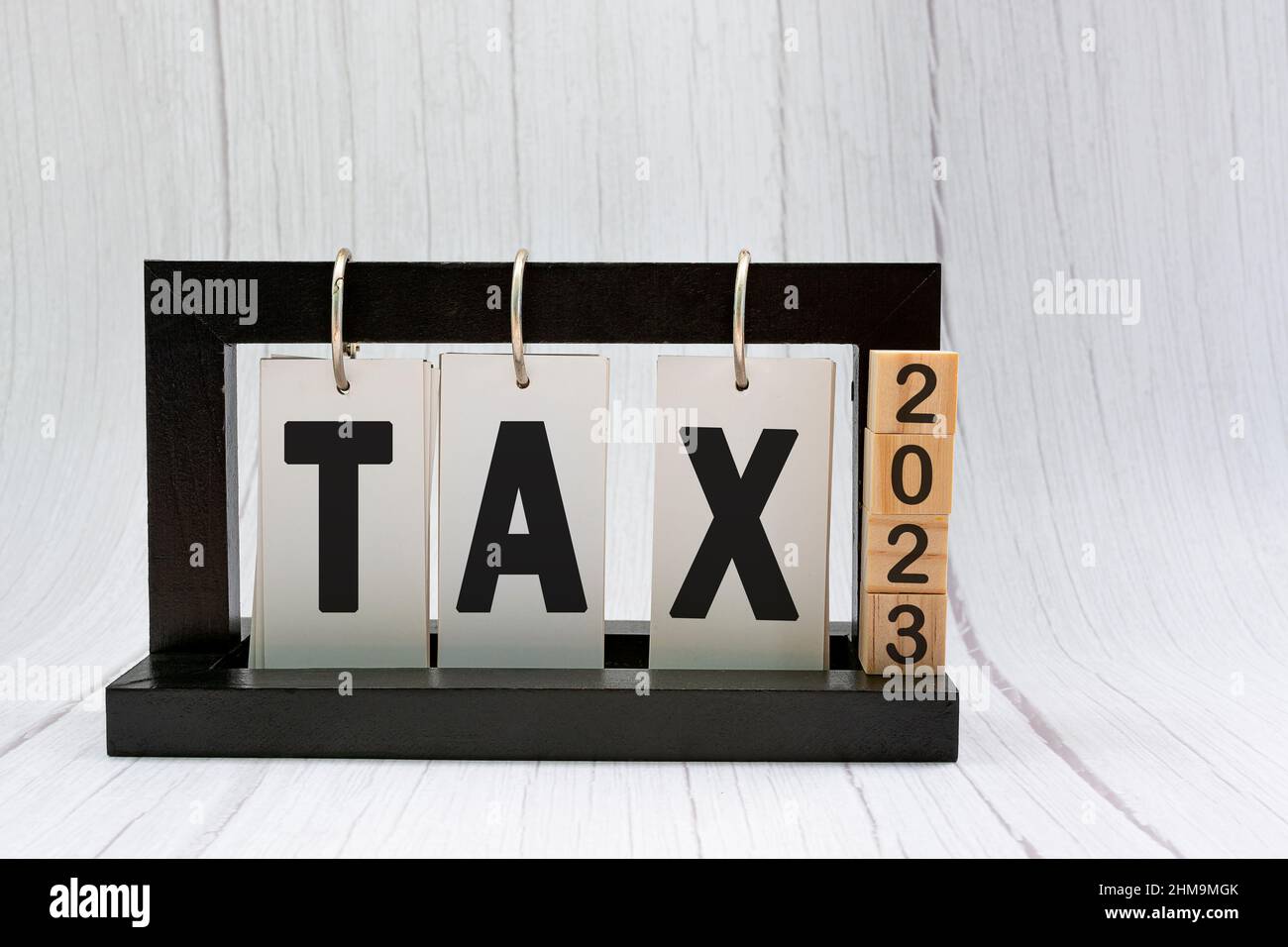 Tax text on paper stand black frame with wooden blocks on white ...