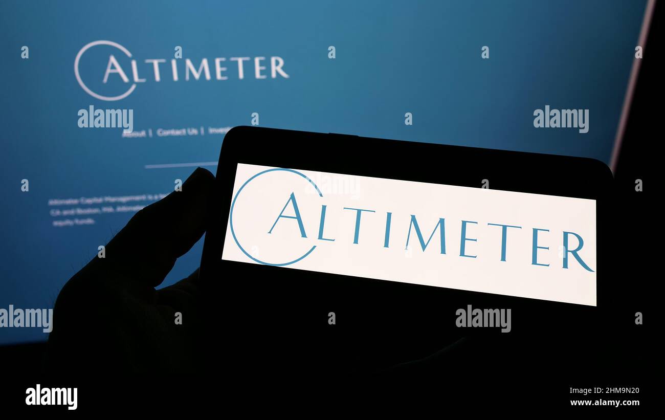 Person holding mobile phone with logo of American company Altimeter ...