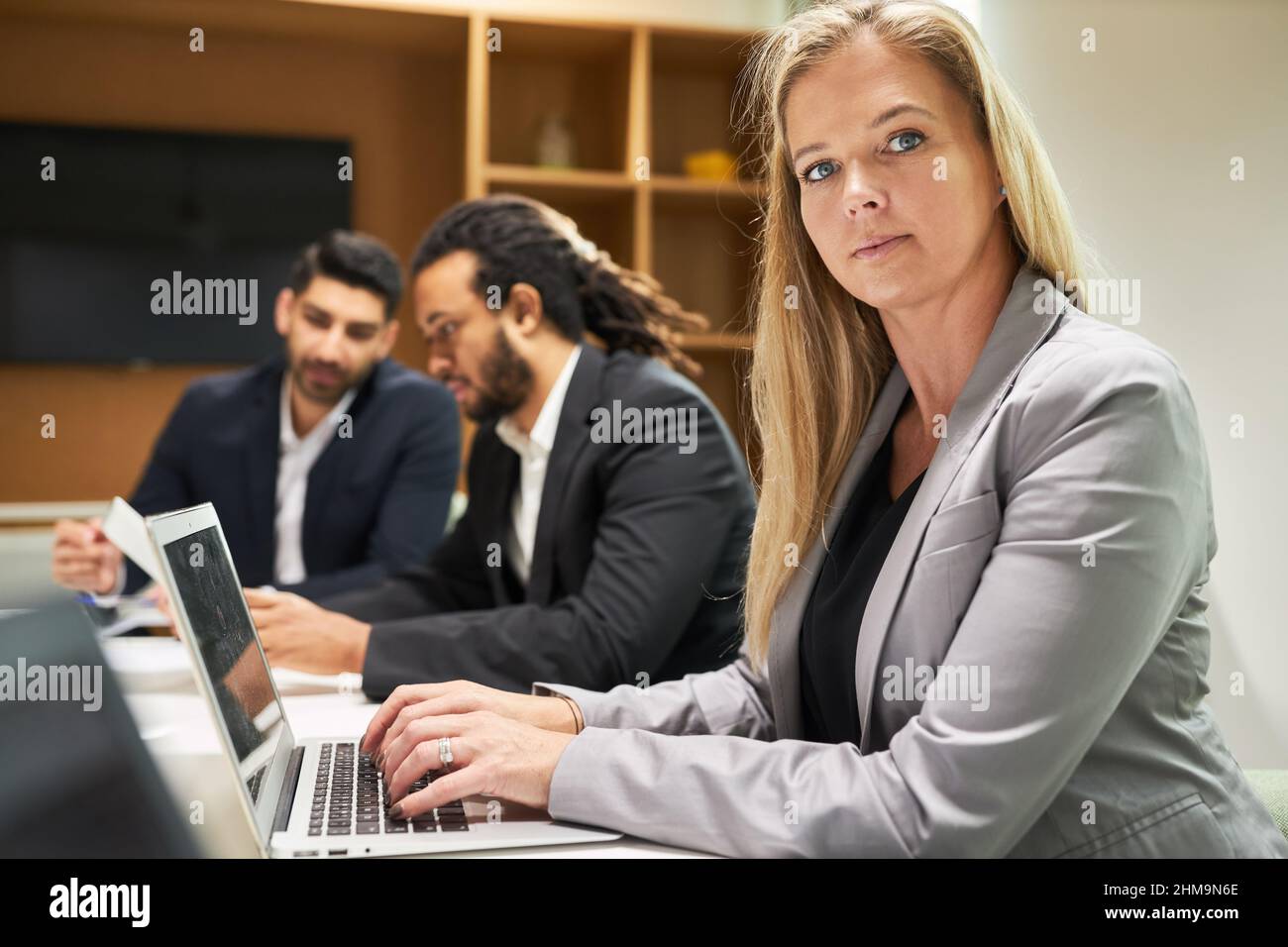 Young businesswoman working on the laptop computer in a computer ...