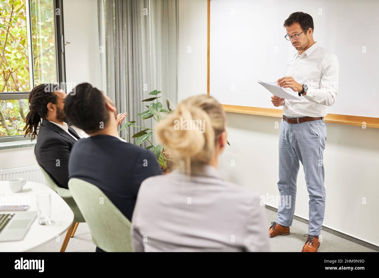 Business man as a coach and teacher giving a presentation in a workshop ...