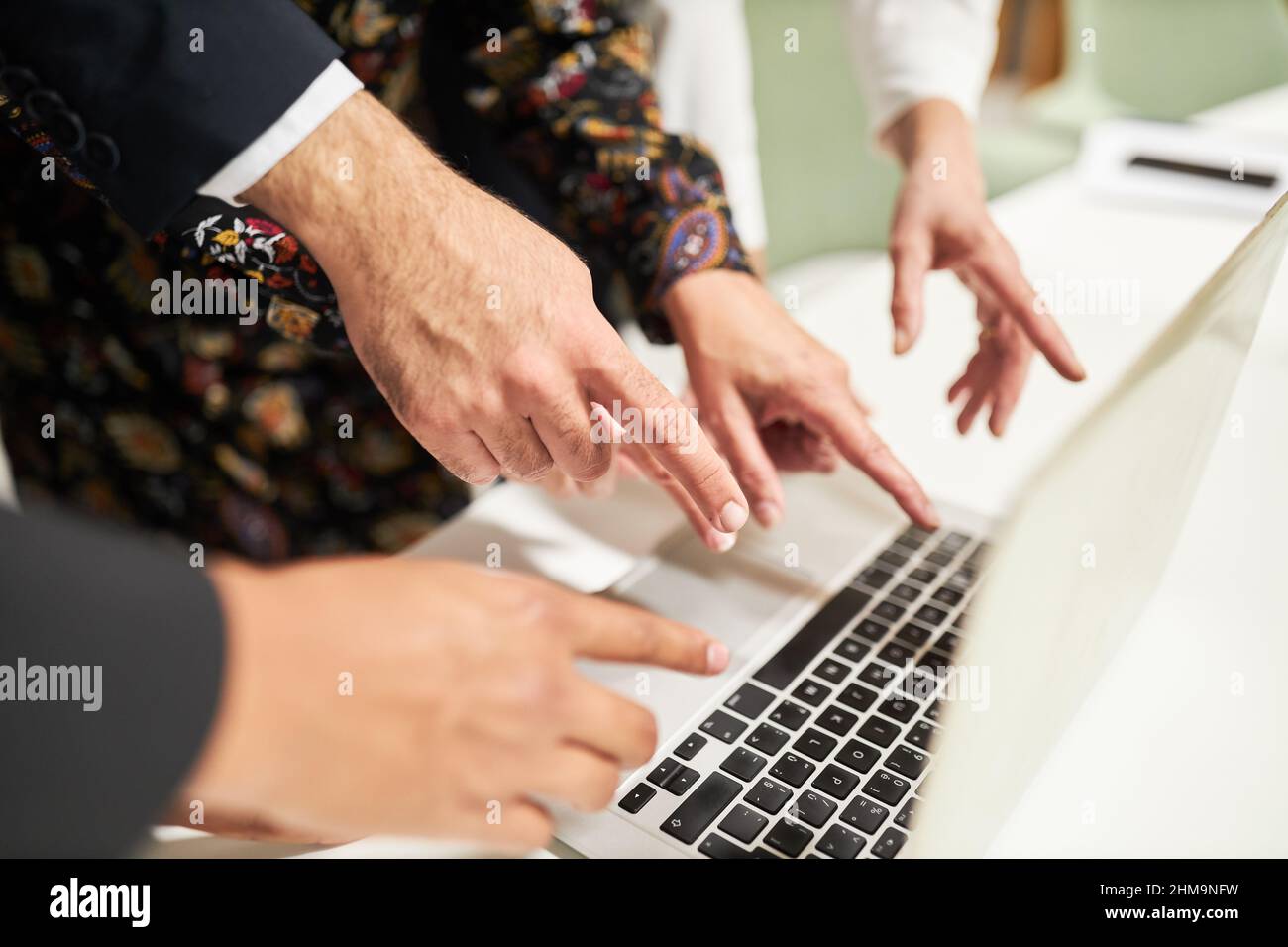 Hands and fingers pointing at computer keyboard symbolizing digital ...