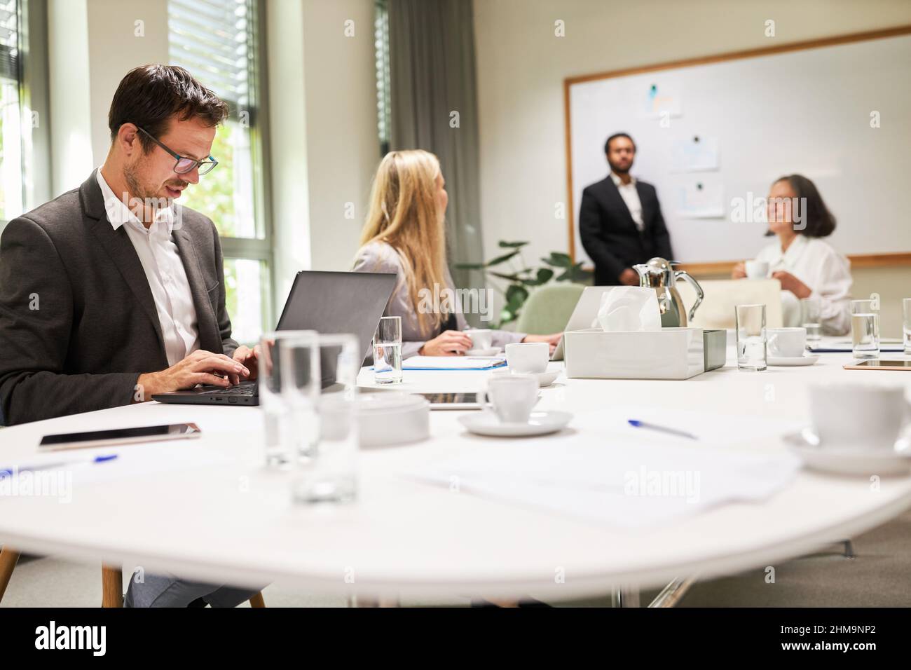 Business team people at the conference table giving a presentation with ...