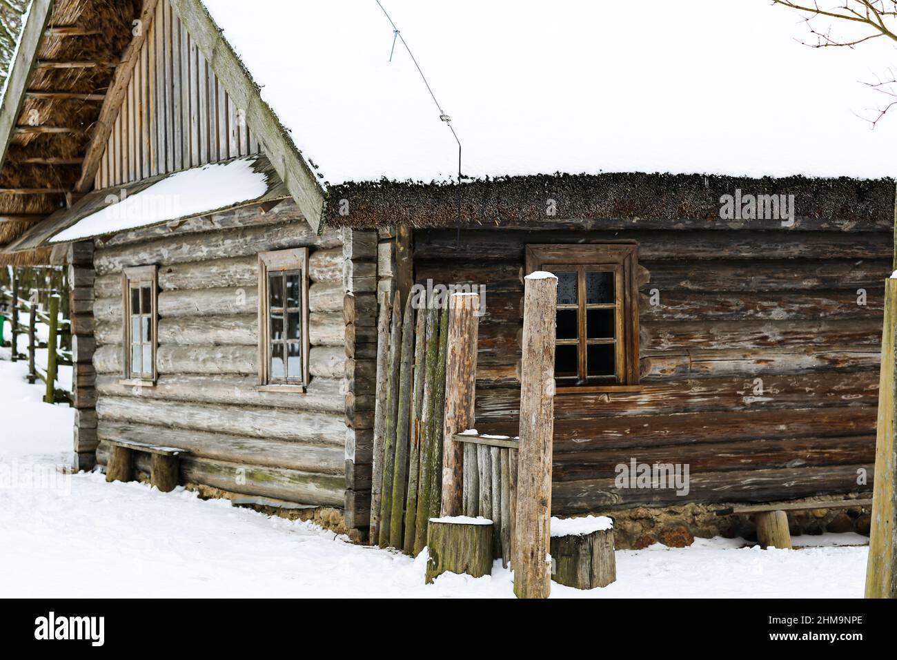 Winter Russian landscape. An old wooden hut, a log house with a ...